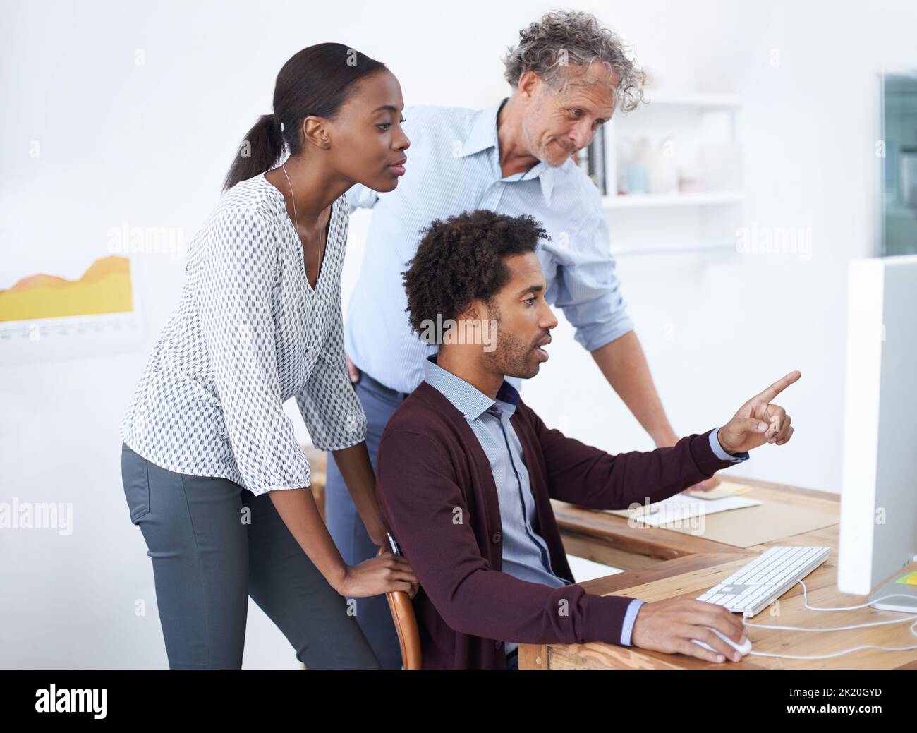 Hes full of incredible ideas. A team of coworkers standing around a ...