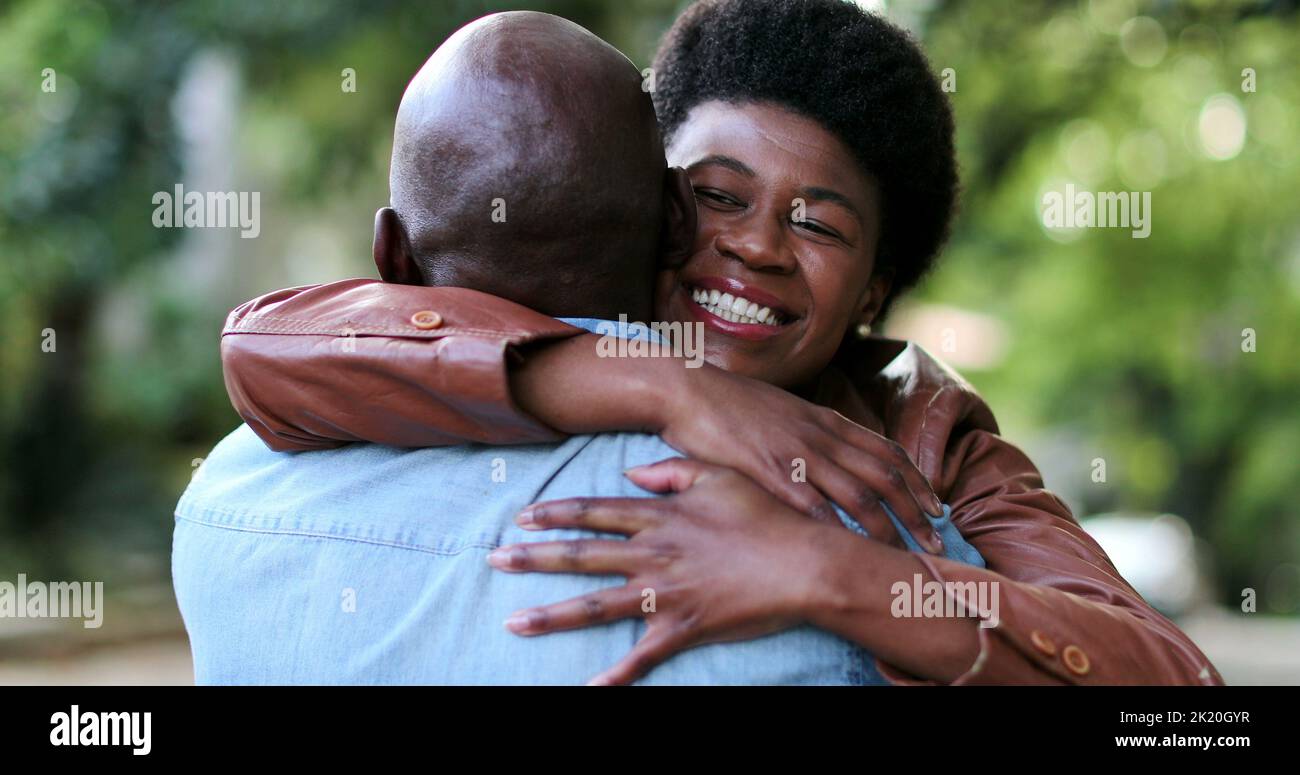Black woman running and hugging man. African couple embrace and hug ...