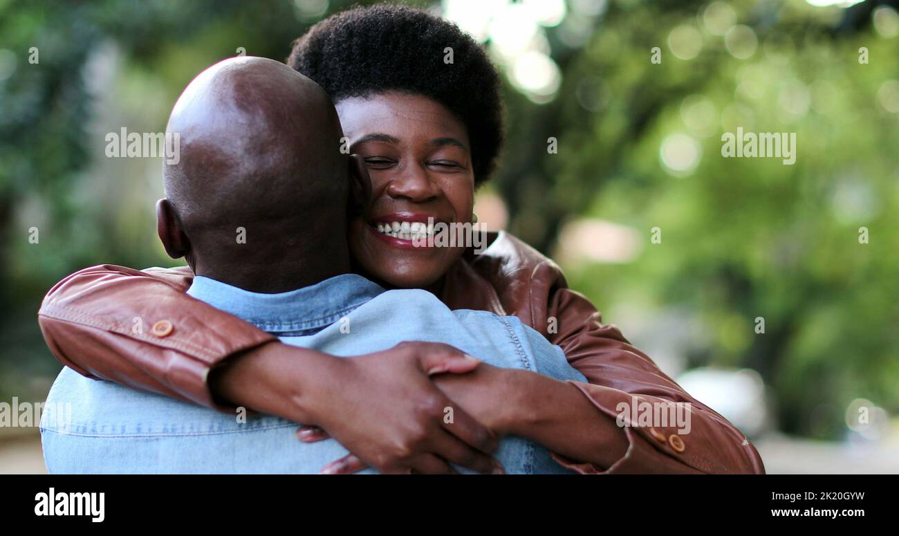 Black woman running and hugging man. African couple embrace and hug ...