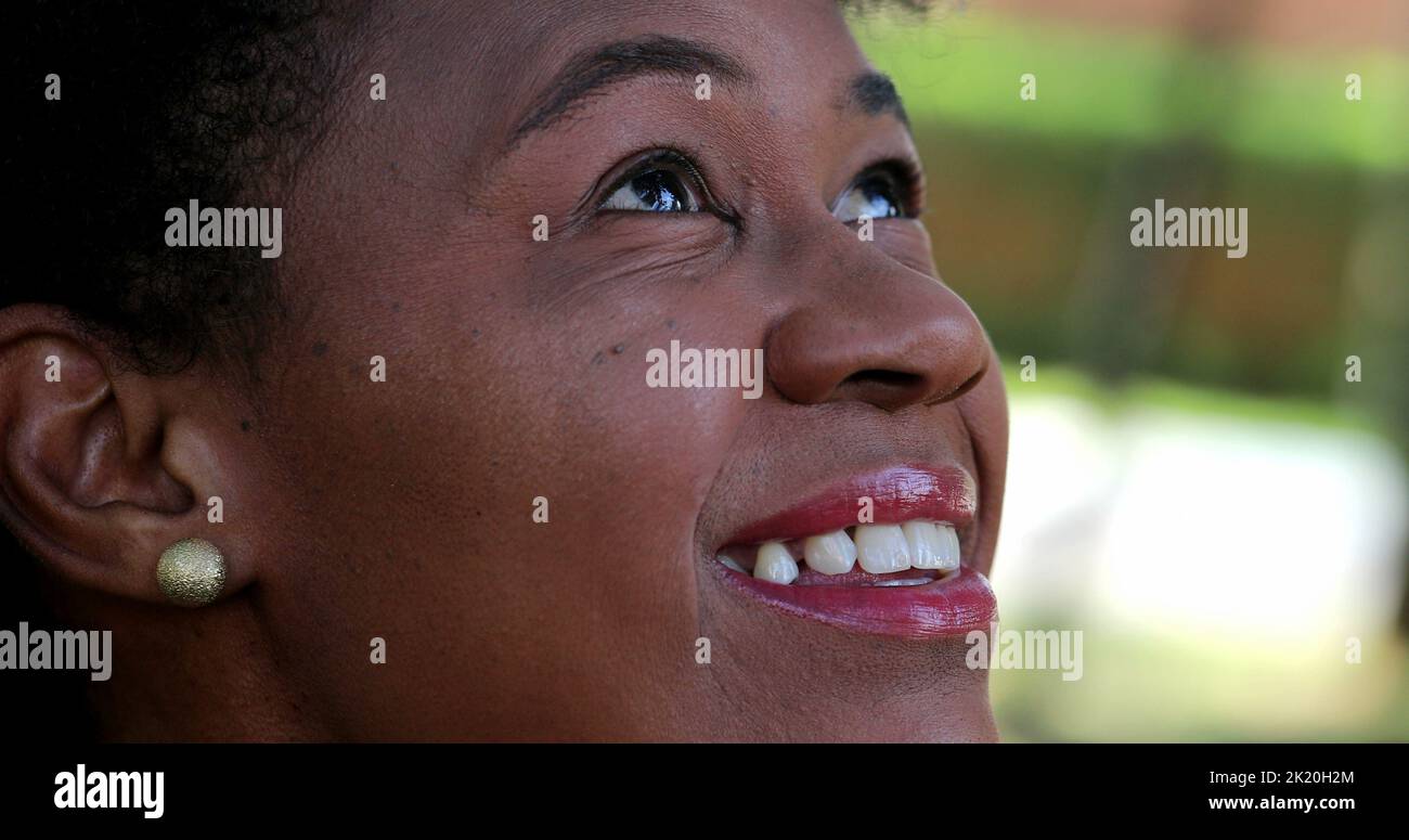 African woman looking to sky with HOPE and FAITH. Black person closing ...