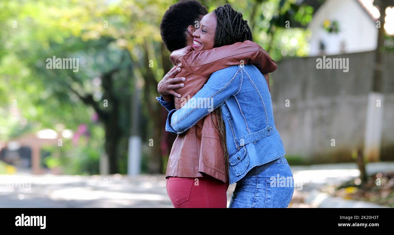 Candid two women embrace. African girls hug and love Stock Photo - Alamy