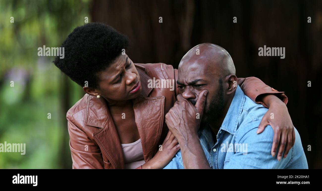 Black woman consoling crying depressed man Stock Photo - Alamy