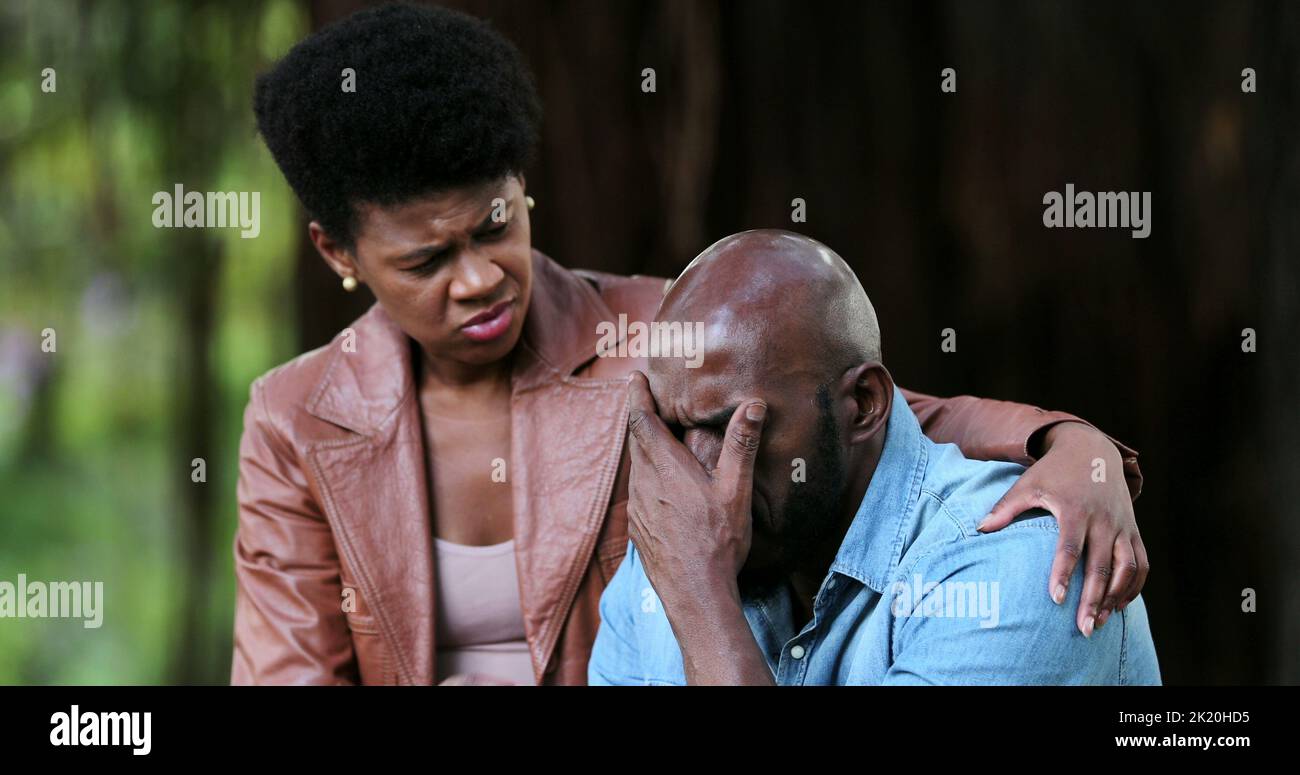 Black woman consoling crying depressed man Stock Photo - Alamy