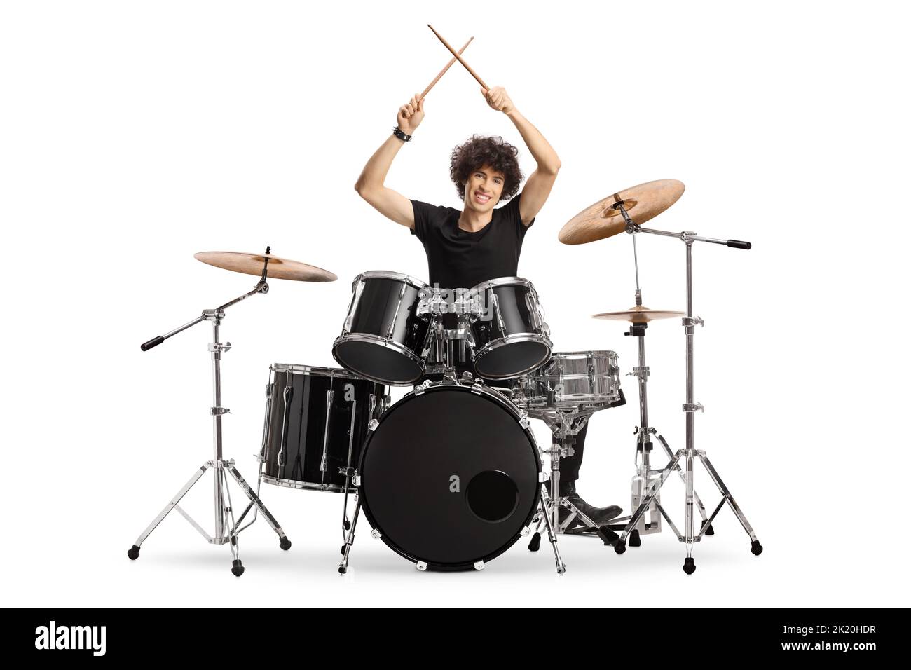 Young male drummer holding drumsticks up isolated on white background ...