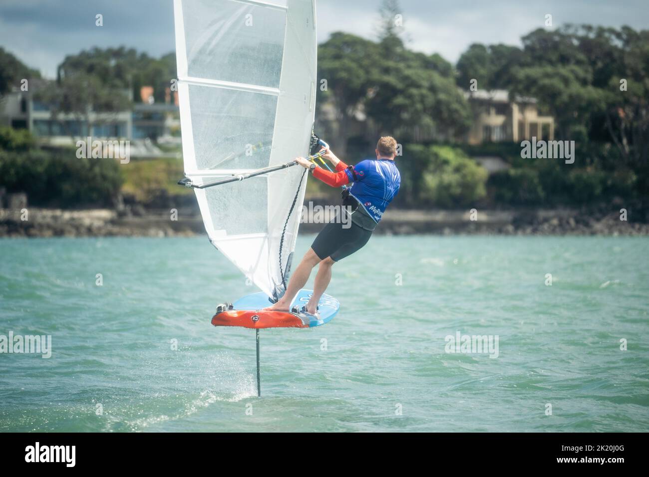 A man competes in a national windsurfing hydrofoil race at the ...