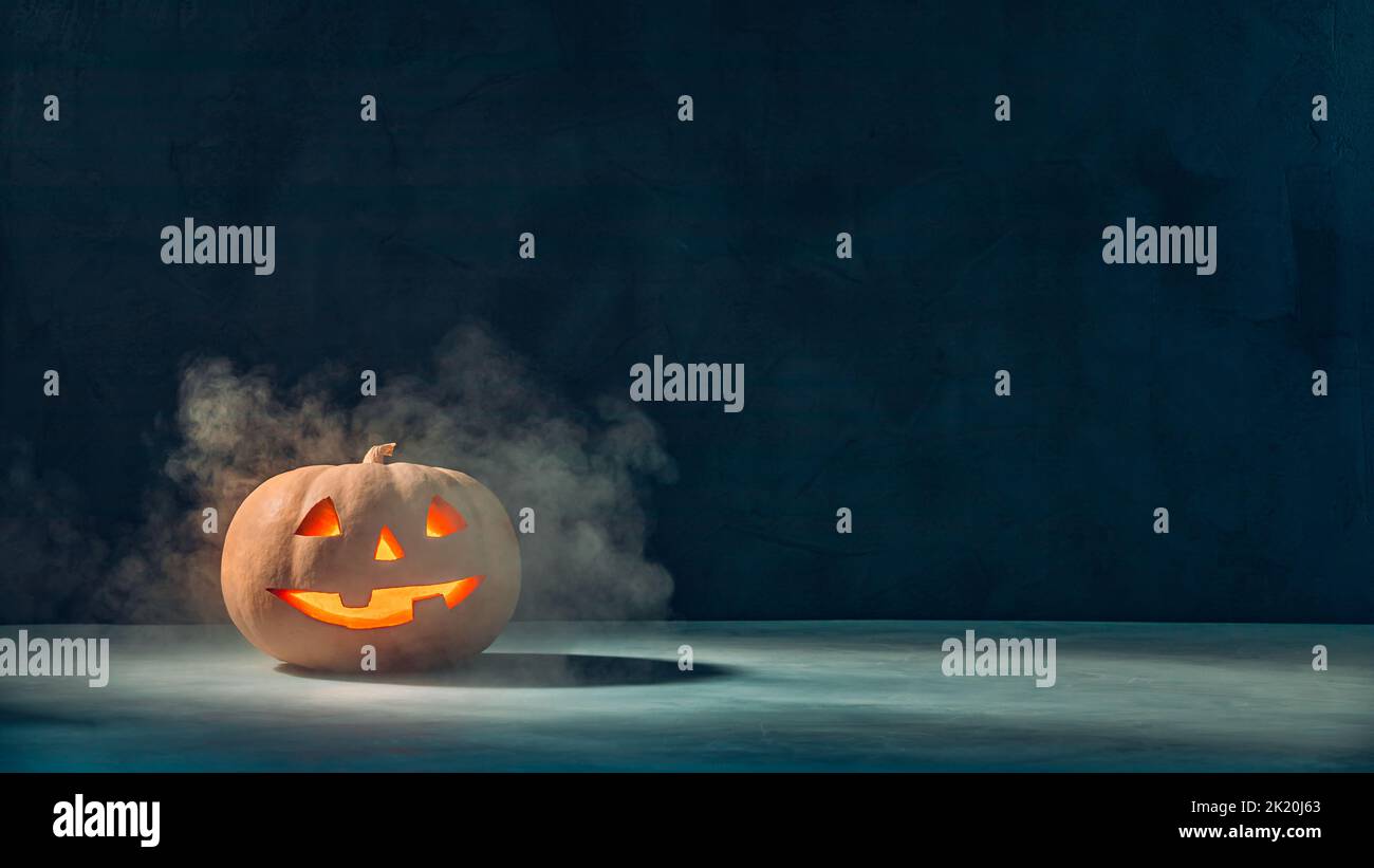 Halloween Jack o'Lantern pumpkin with smoke in the dark Stock Photo - Alamy