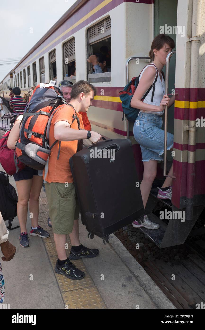 Young Travellers with Luggae Climb aboard the train in Ayutthaya ...