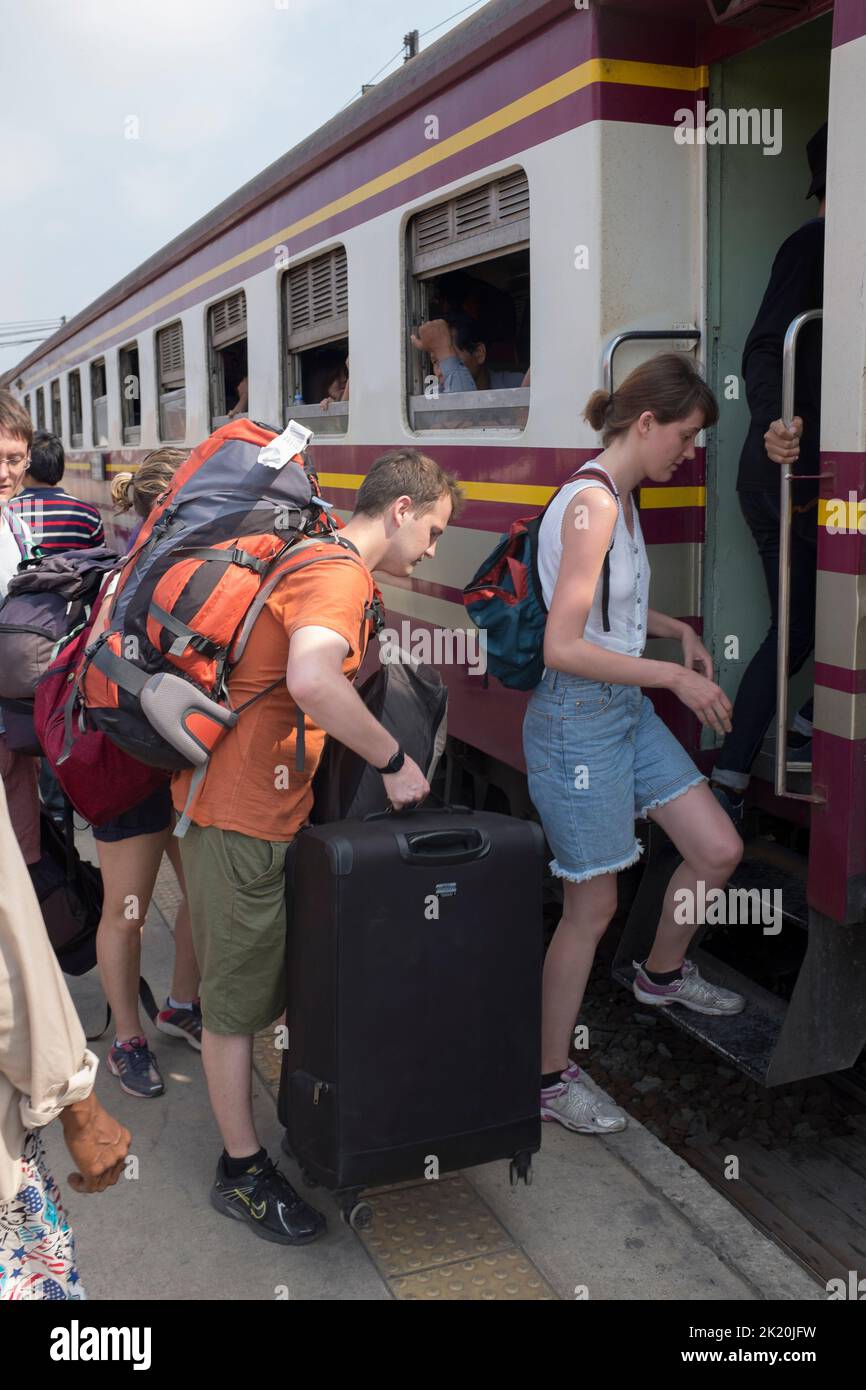 Young Travellers with Luggae Climb aboard the train in Ayutthaya ...