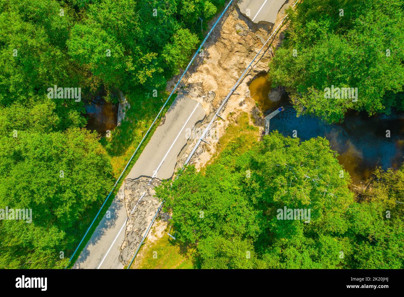 The asphalt road and bridge washed out and destroyed after the heavy ...