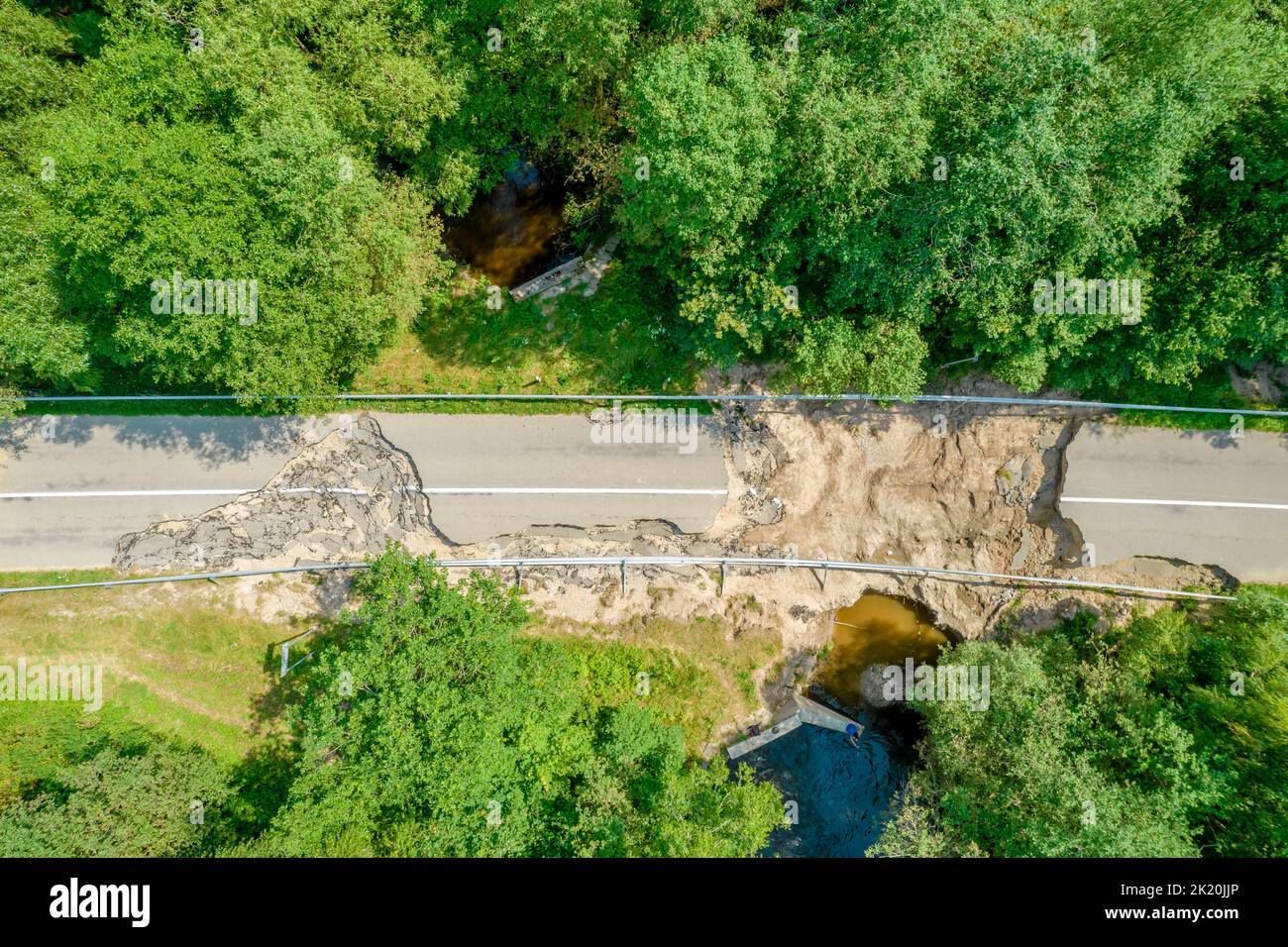 The asphalt road and bridge washed out and destroyed after the heavy ...