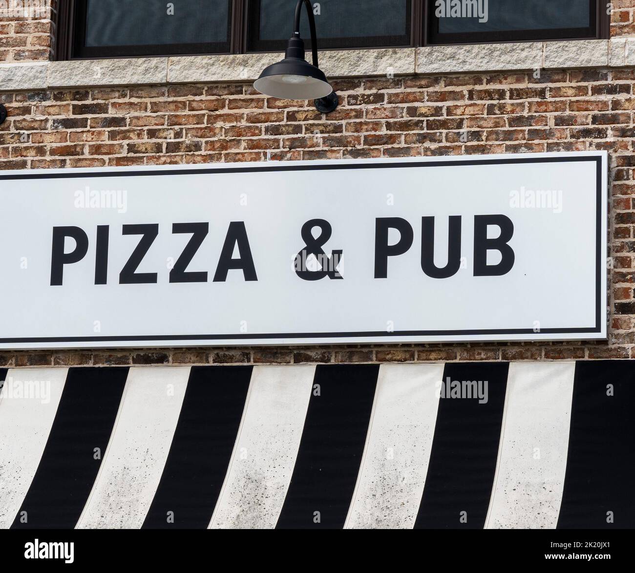 A pizza and hub sign on the building Stock Photo - Alamy