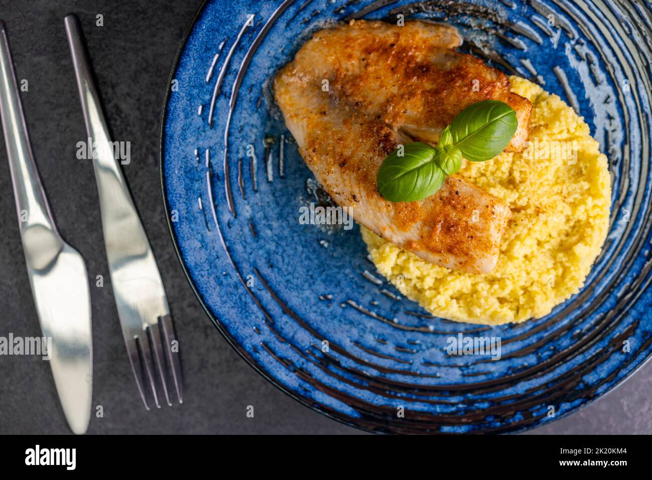spicy fillet of white cod with couscous Stock Photo - Alamy