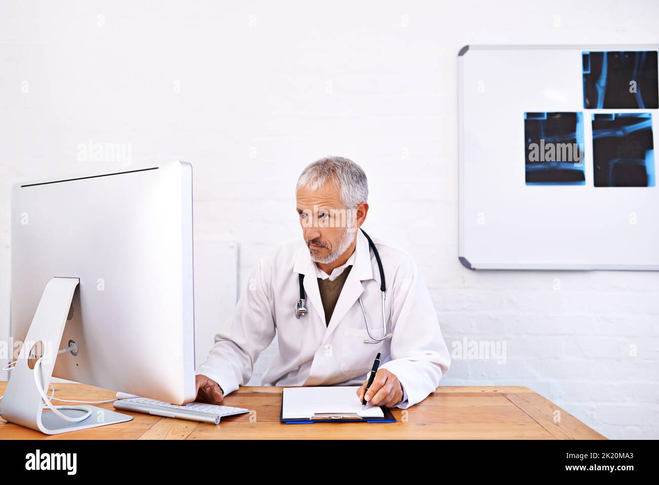 Doctor holding pen medical chart hi-res stock photography and images ...