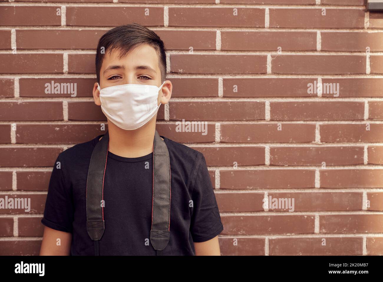 A cute little kid with green eyes wearing a mask Stock Photo - Alamy