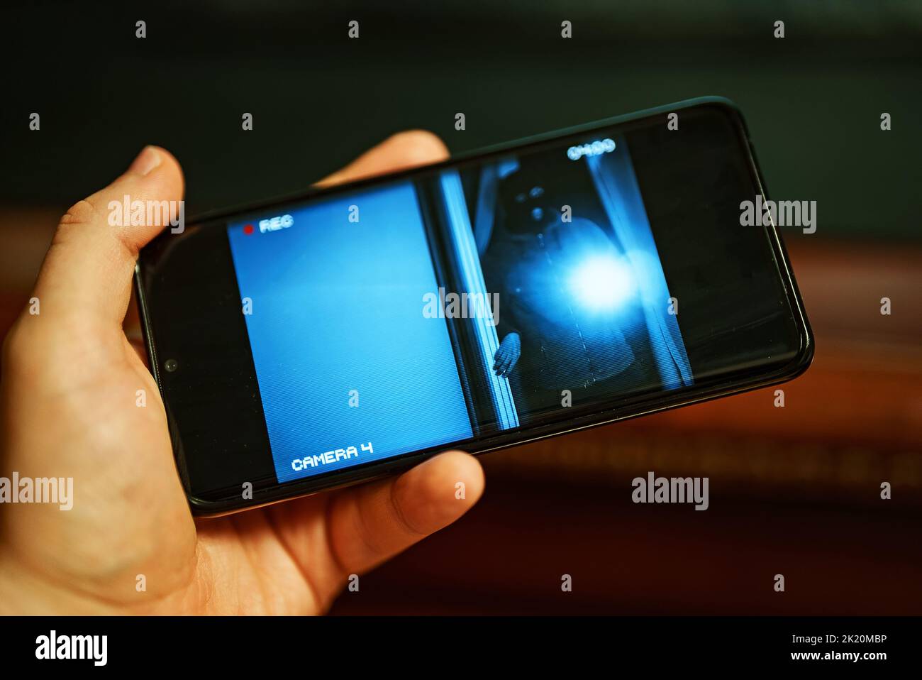 The thief breaks into the house. Security camera on mobile app Stock ...