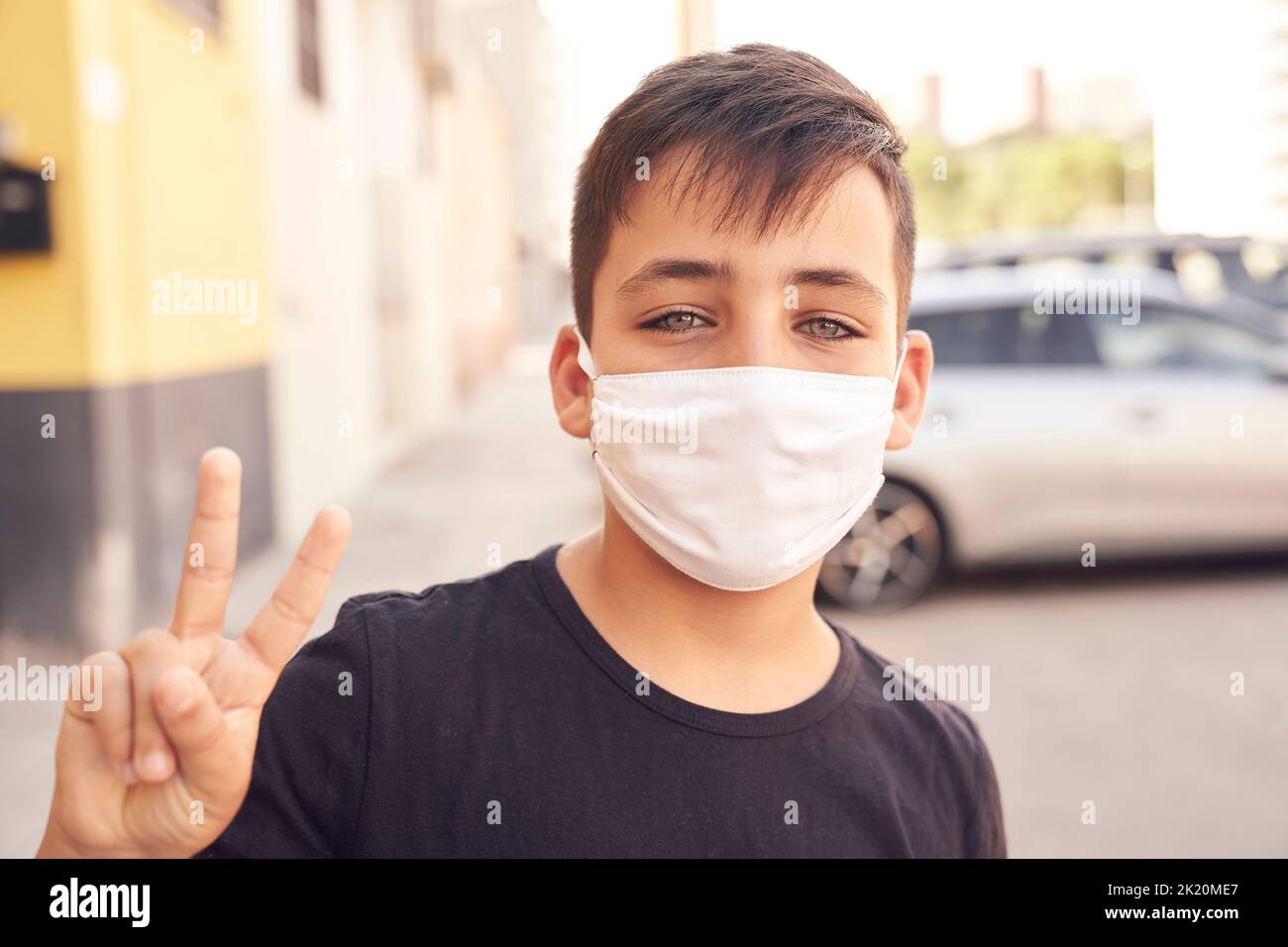 A cute little kid with green eyes wearing a mask Stock Photo - Alamy