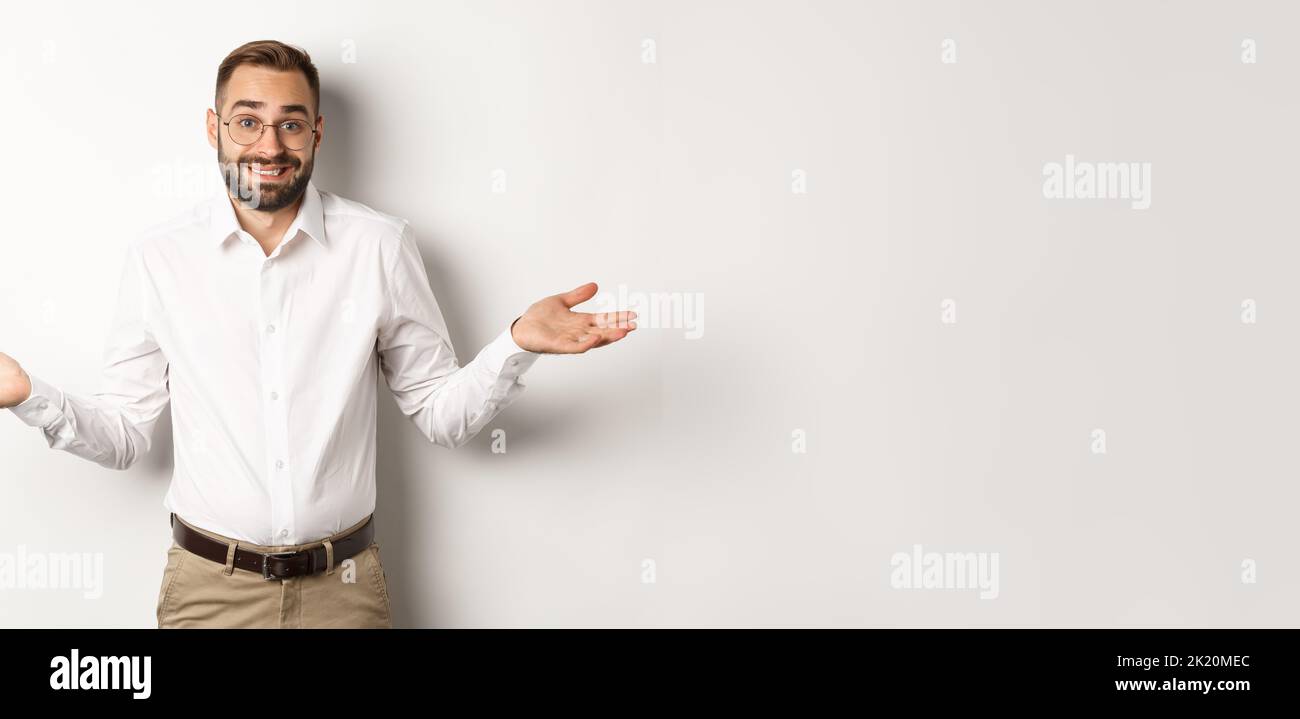 Confused smiling businessman dont know, shrugging and saying sorry ...