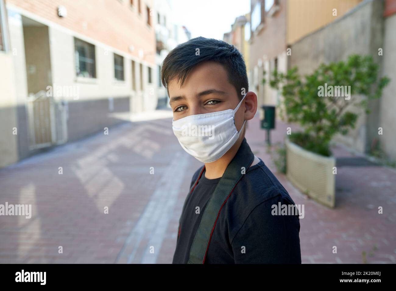 A cute little kid with green eyes wearing a mask Stock Photo - Alamy