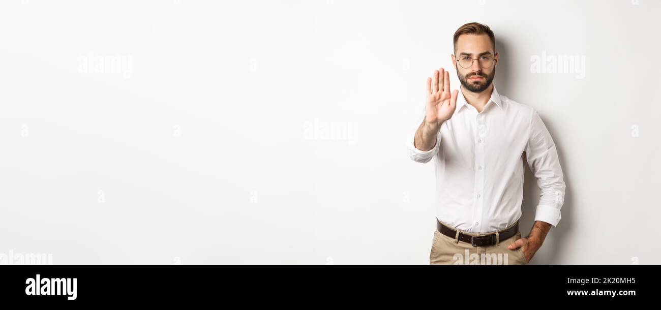 Serious boss in glasses showing stop sign, telling no, forbidding ...