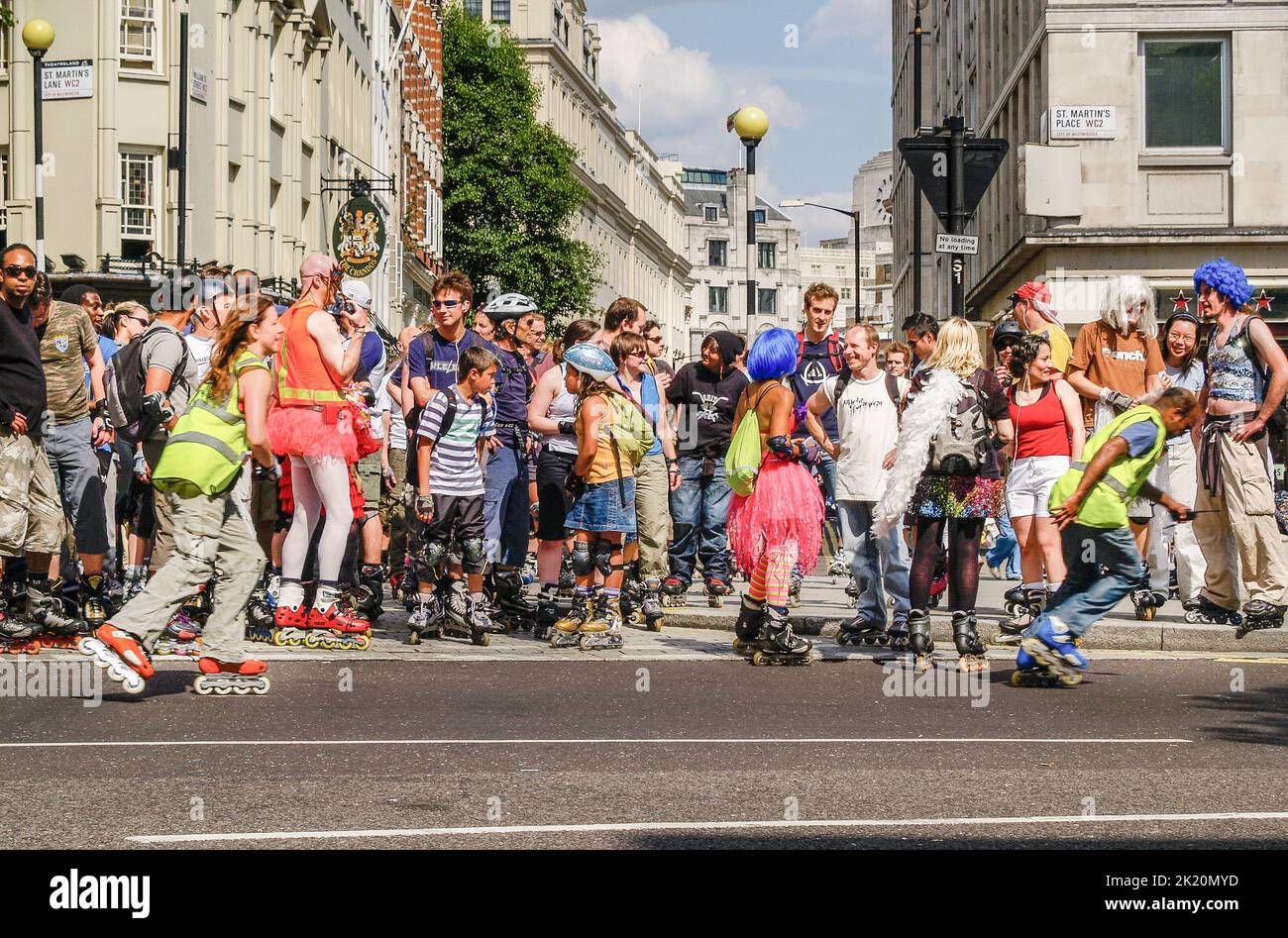 Large group diverse people meet-up on city street for a roller-blade ...