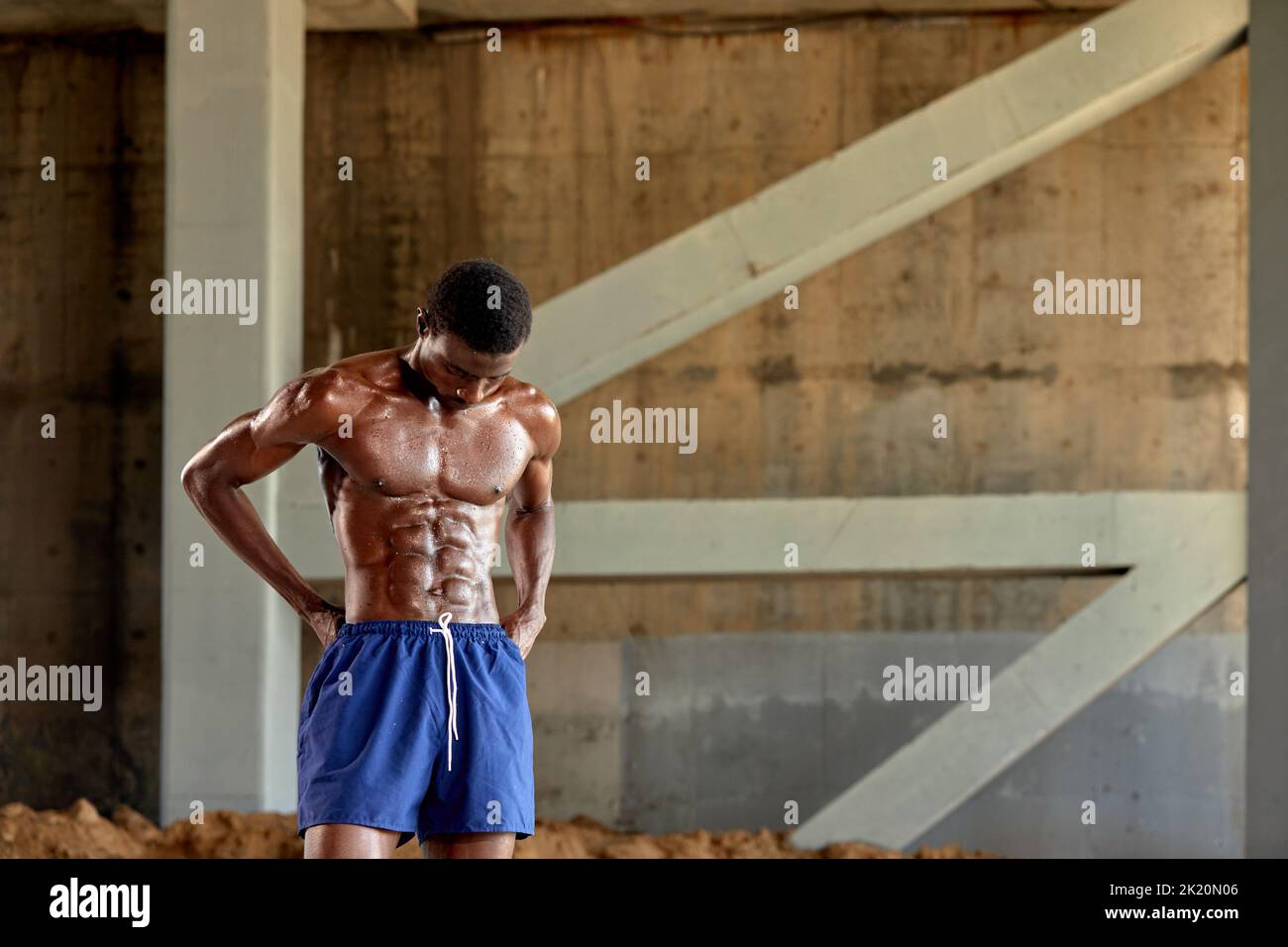 Handsome African American sportman standing on the street while taking ...