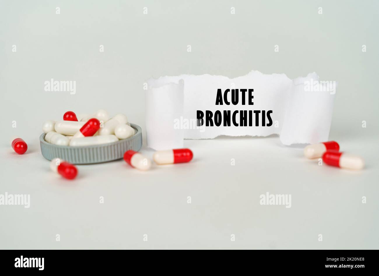 Medical concept. On a gray background, medical capsules and a paper ...