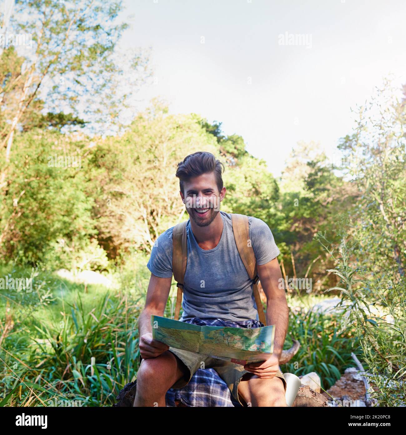 Put down the map and get wonderfully lost. a handsome hiker using a map ...