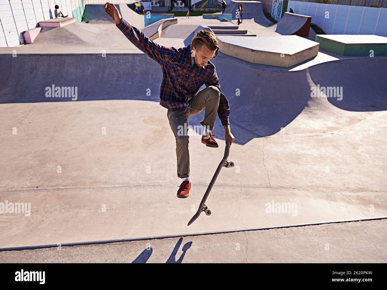 Hes got style. A young man doing tricks on his skateboard at the skate ...