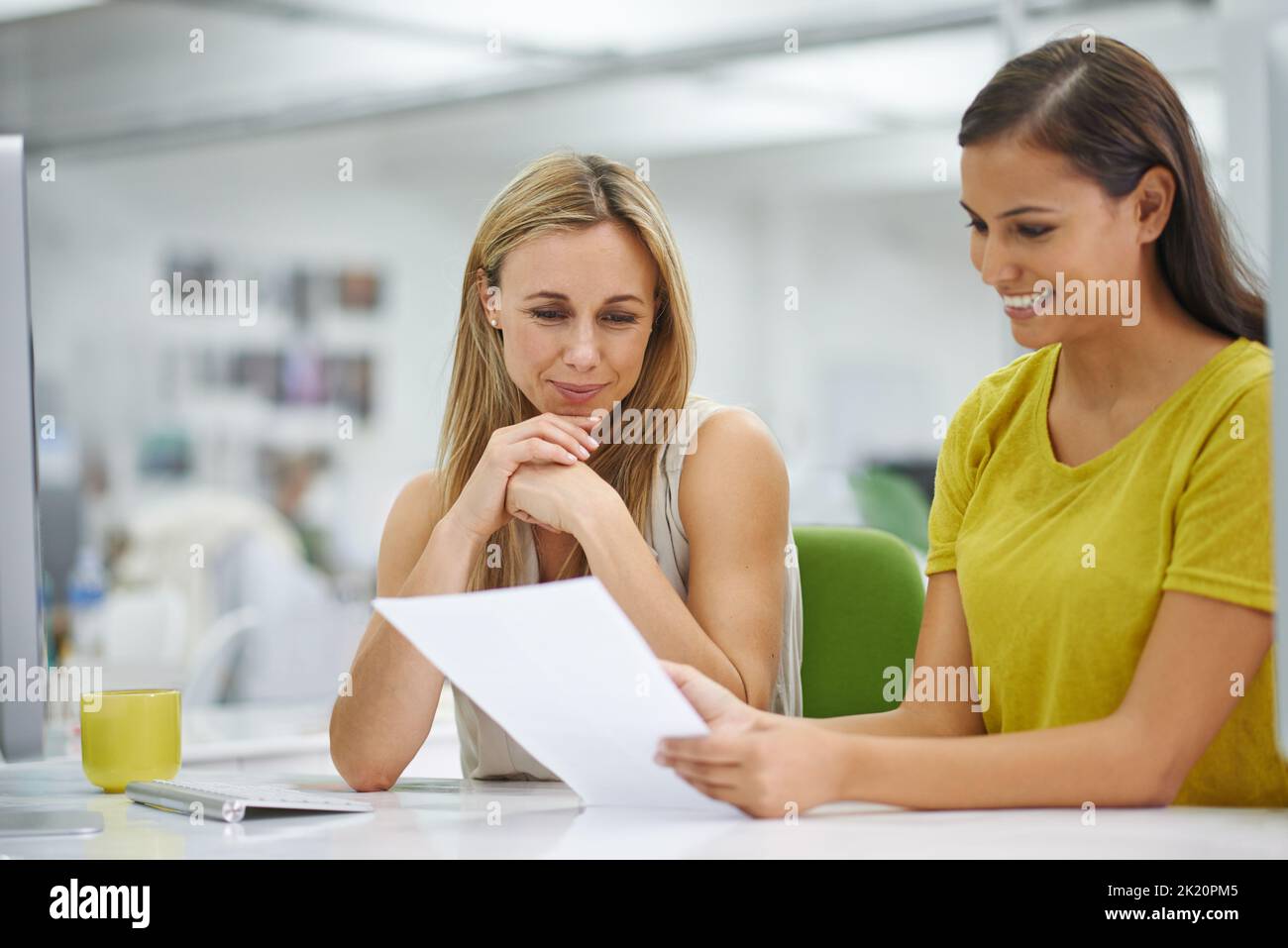 I got a glowing report. two attractive female colleagues looking over ...