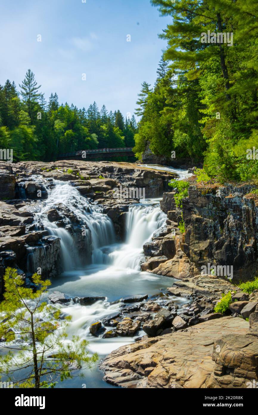 A Scenic view of a water cascade in long exposure effect flowing on ...