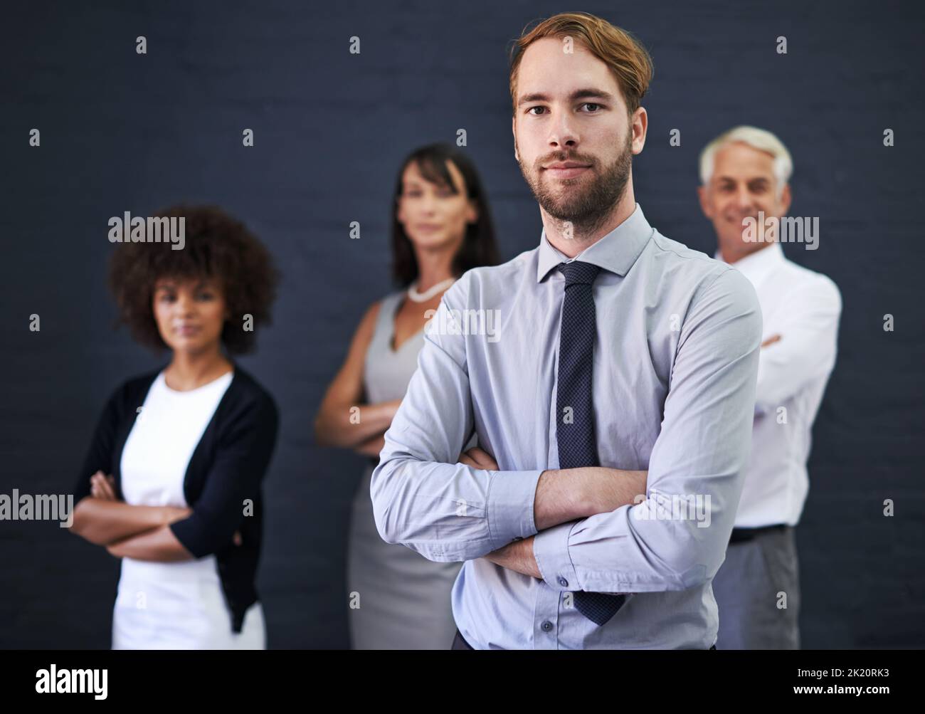 We strive for excellence. a young professional man standing in front of ...