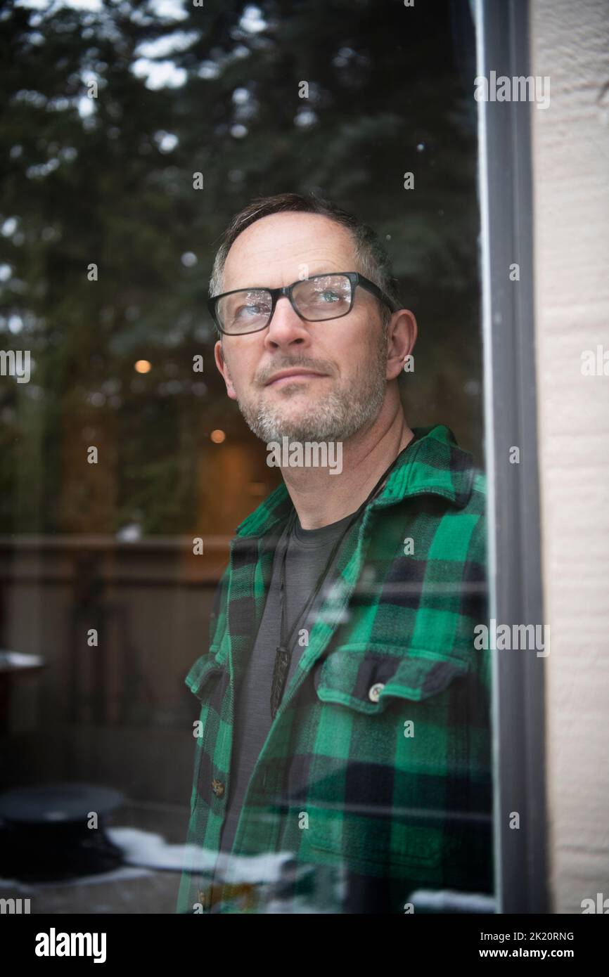 Adult look out window of home hi-res stock photography and images - Alamy