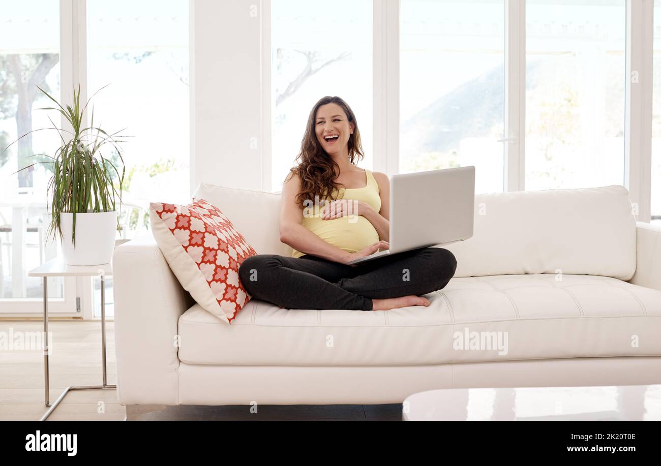 Using technology to set her mind at ease. a young pregnant woman ...