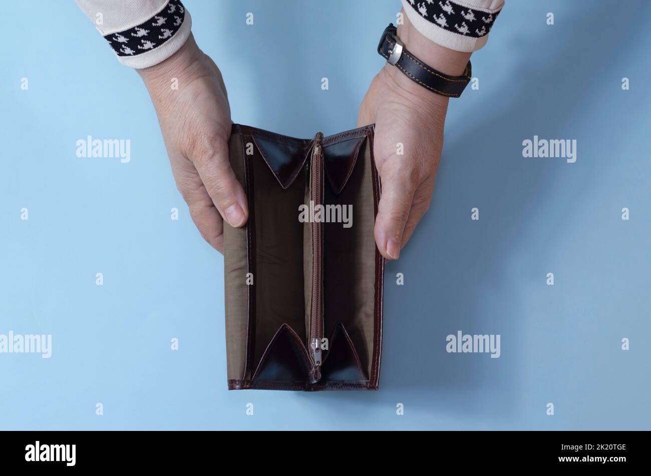 Hands of elderly woman with empty wallet on white background. Concept ...