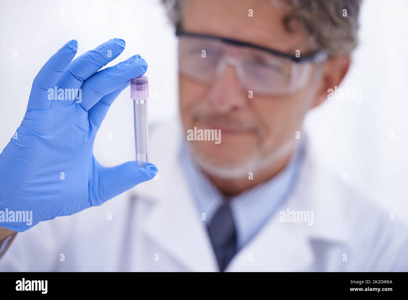 Crucial lab equipment. A cropped shot of a mature scientist looking at ...