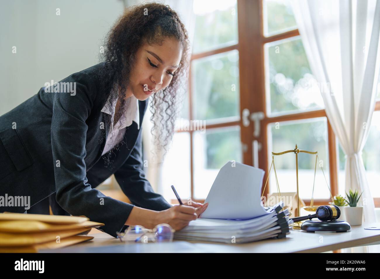 Portrait of African Americans female lawyer opening lawsuit documents ...
