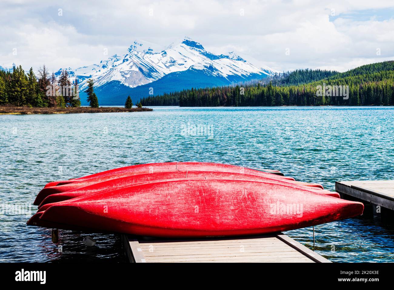 Colorful canoes on dock; Curly Phillips' Boat House; Maligne Lake ...