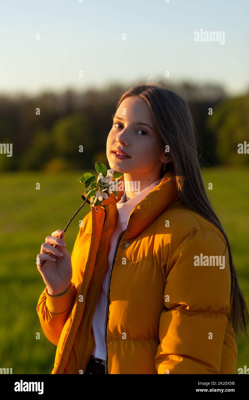 Portrait of a beautiful casual weared teenage girl outdoors in spring ...