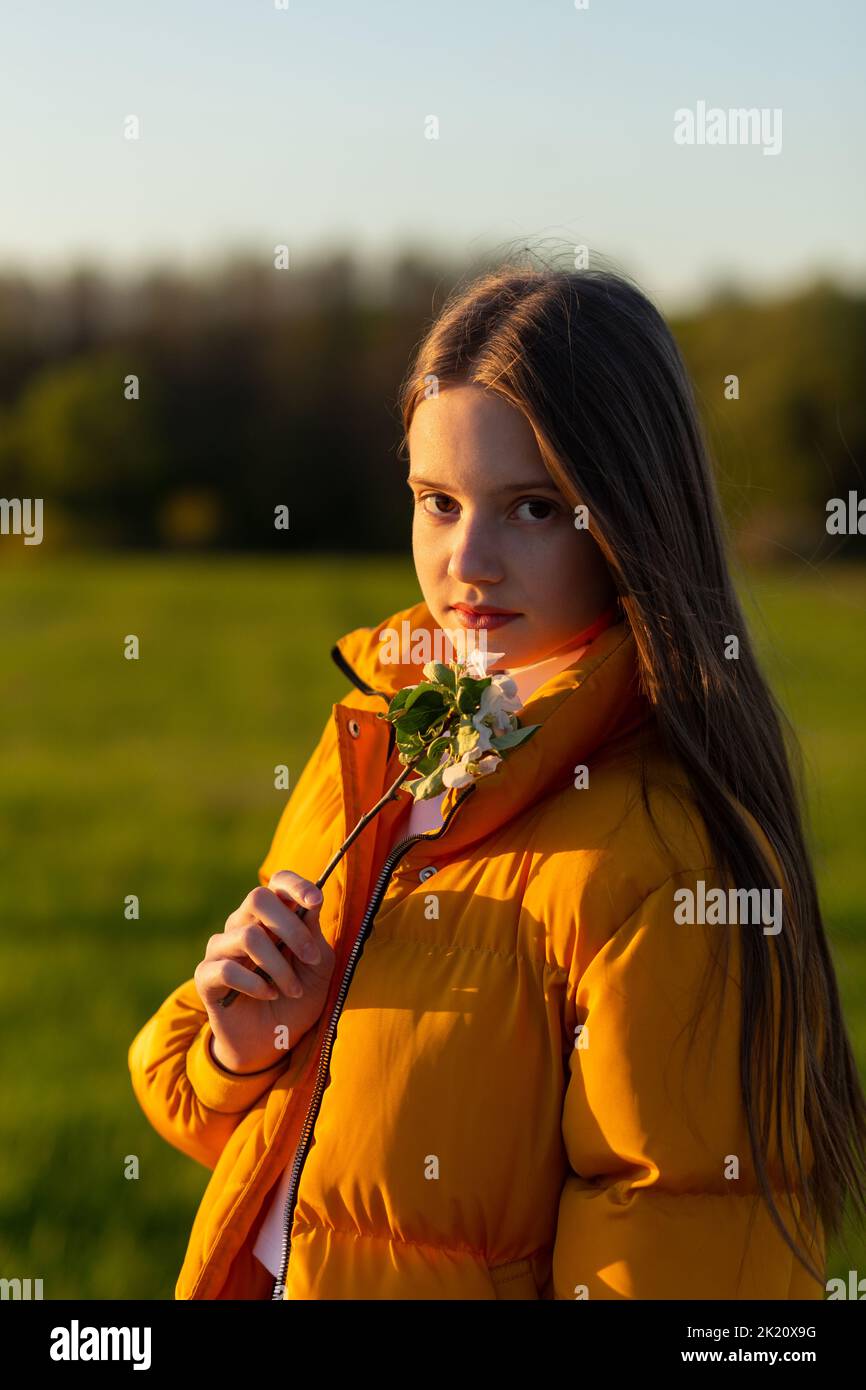 Portrait of a beautiful casual weared teenage girl outdoors in spring ...