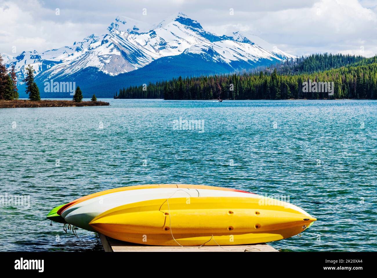 Colorful canoes on dock; Curly Phillips' Boat House; Maligne Lake ...