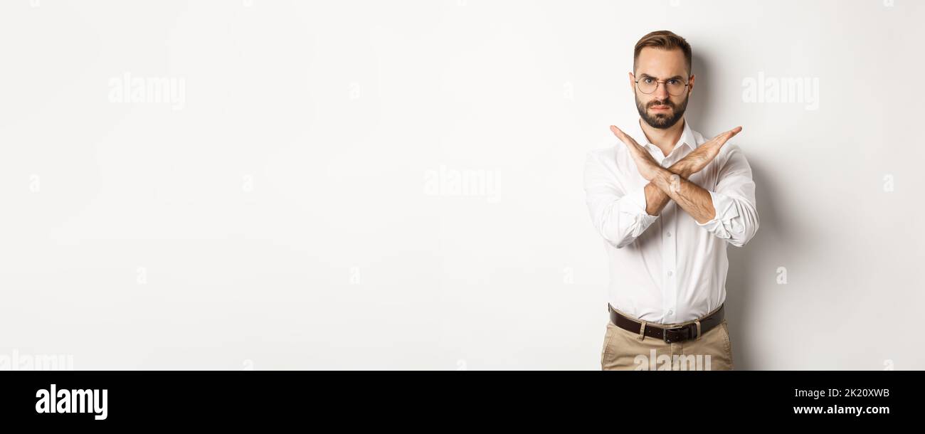 Angry businessman frowning and showing cross, stop you, telling no and ...
