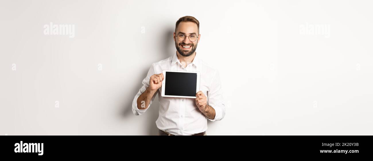 Shopping and technology. Handsome man showing digital tablet screen ...