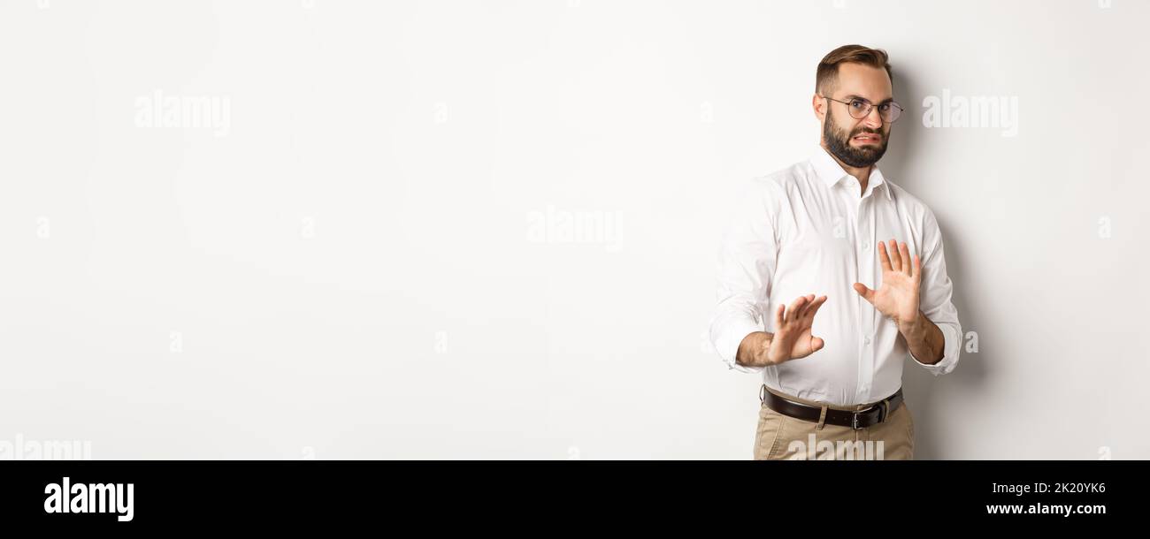 Disgusted businessman rejecting something bad, cringe from aversion ...