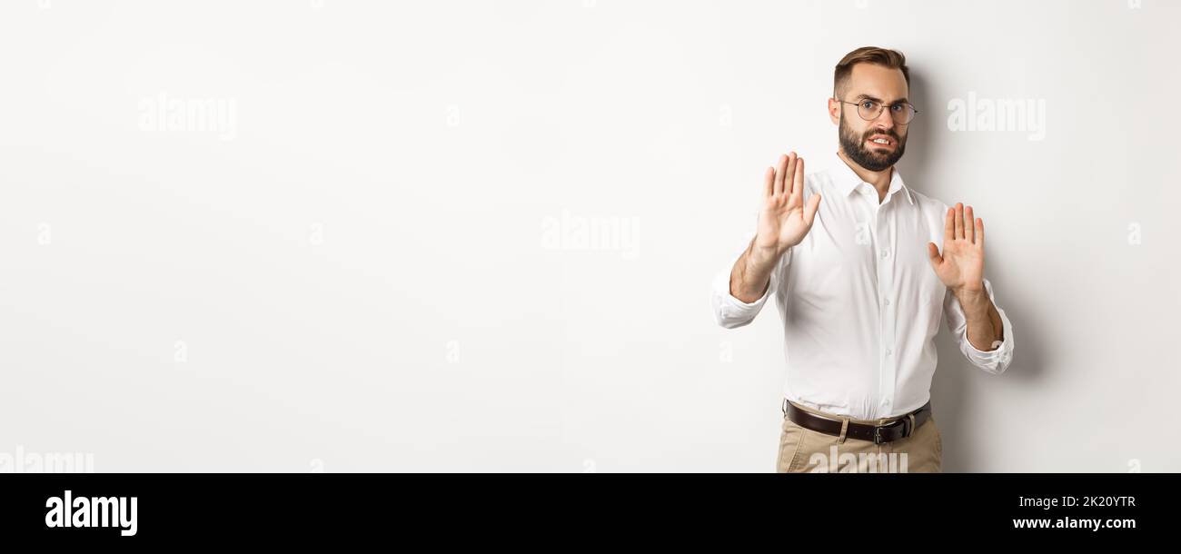Displeased man rejecting something disturbing, showing stop sign and ...