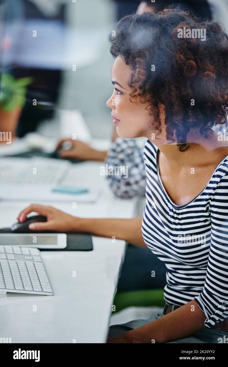Trouble shooting tech is my specialty. a young office worker sitting at ...