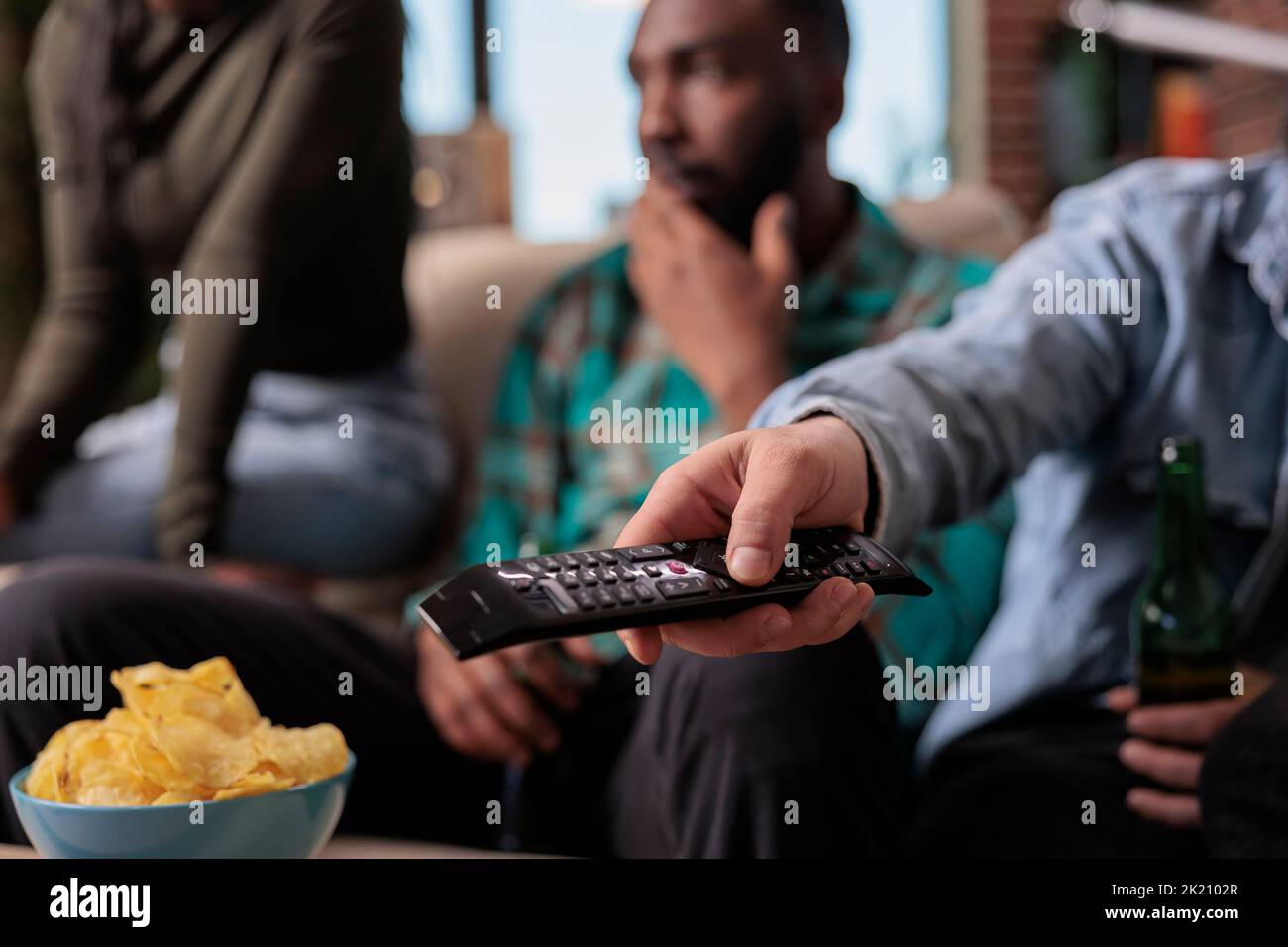 Diverse people switching tv channels hi-res stock photography and ...