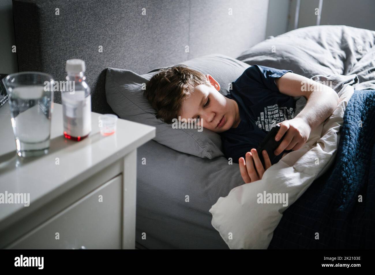 Sick boy in bed hi-res stock photography and images - Alamy