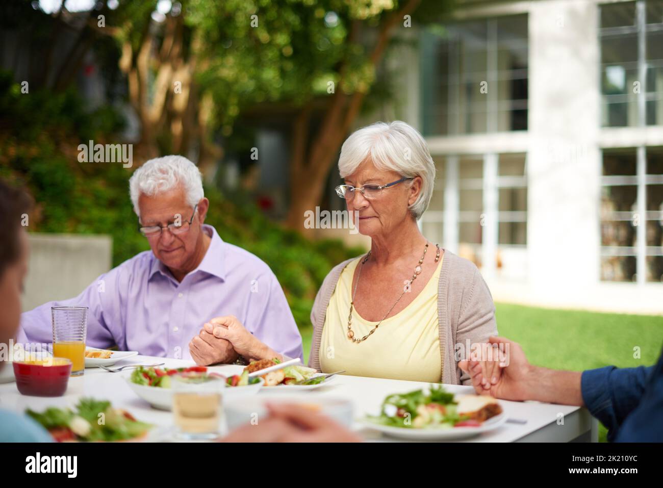 Thankful for what we are about to receive. a family saying grace ...