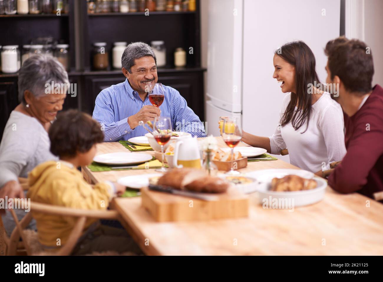 Cheers to the best family. A shot of a happy family sharing a meal ...