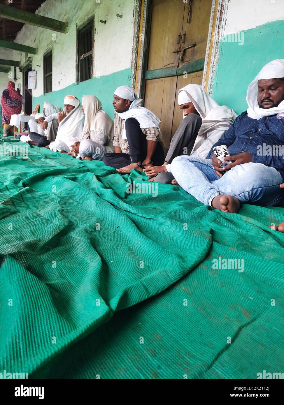 A view of Indian people sitting together at a death ceremony Stock ...
